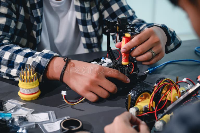 Engineer Asian Students Assembling Robotics Kits. Learning Mechanical Control, Robotics Combines ...