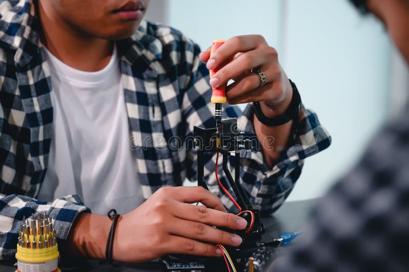 Engineer Asian Students Assembling Robotics Kits. Learning Mechanical ...