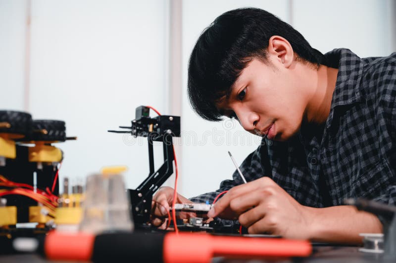 Engineer Asian Students Assembling Robotics Kits. Learning Mechanical ...