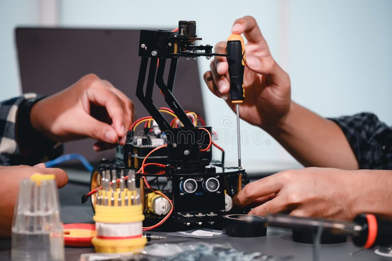 Engineer Asian Students Assembling Robotics Kits. Learning Mechanical Control, Robotics Combines ...