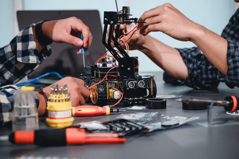 Engineer Asian Students Assembling Robotics Kits. Learning Mechanical ...
