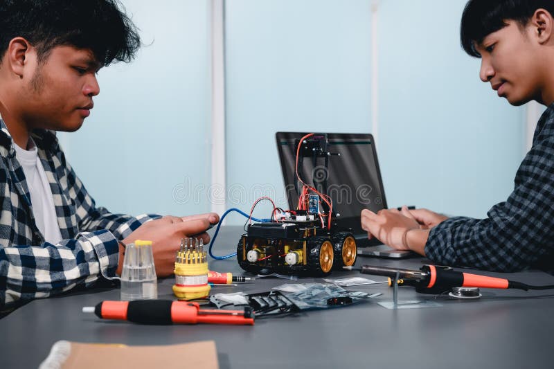 Engineer Asian Students Assembling Robotics Kits. Learning Mechanical ...