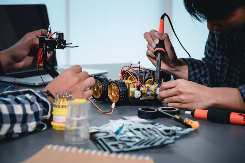 Engineer Asian Students Assembling Robotics Kits. Learning Mechanical ...