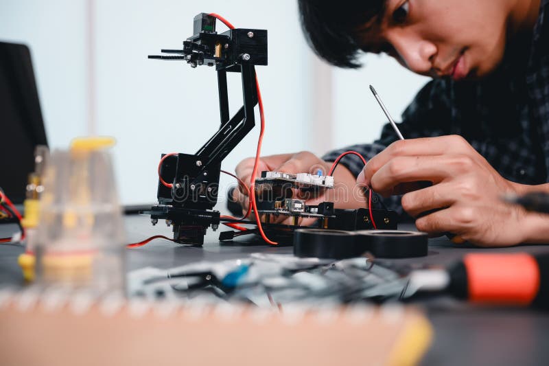 Engineer Asian Students Assembling Robotics Kits. Learning Mechanical ... Engineer Asian Students Assembling Robotics Kits. Learning Mechanical ...