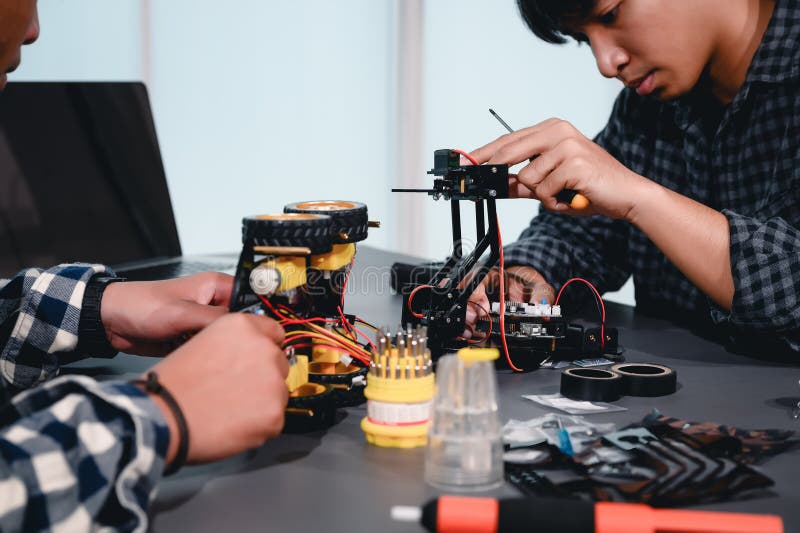 Engineer Asian Students Assembling Robotics Kits. Learning Mechanical ... Engineer Asian Students Assembling Robotics Kits. Learning Mechanical ...