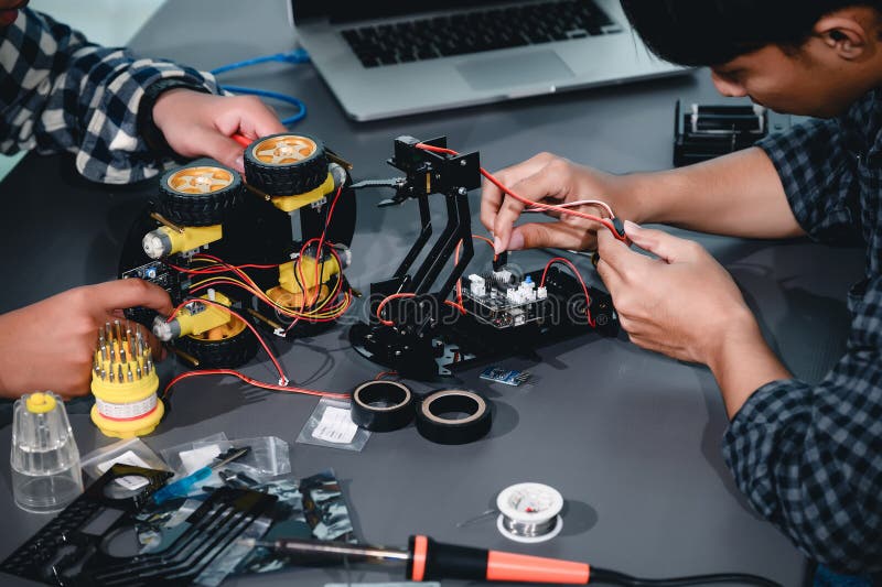 Engineer Asian Students Assembling Robotics Kits. Learning Mechanical ...