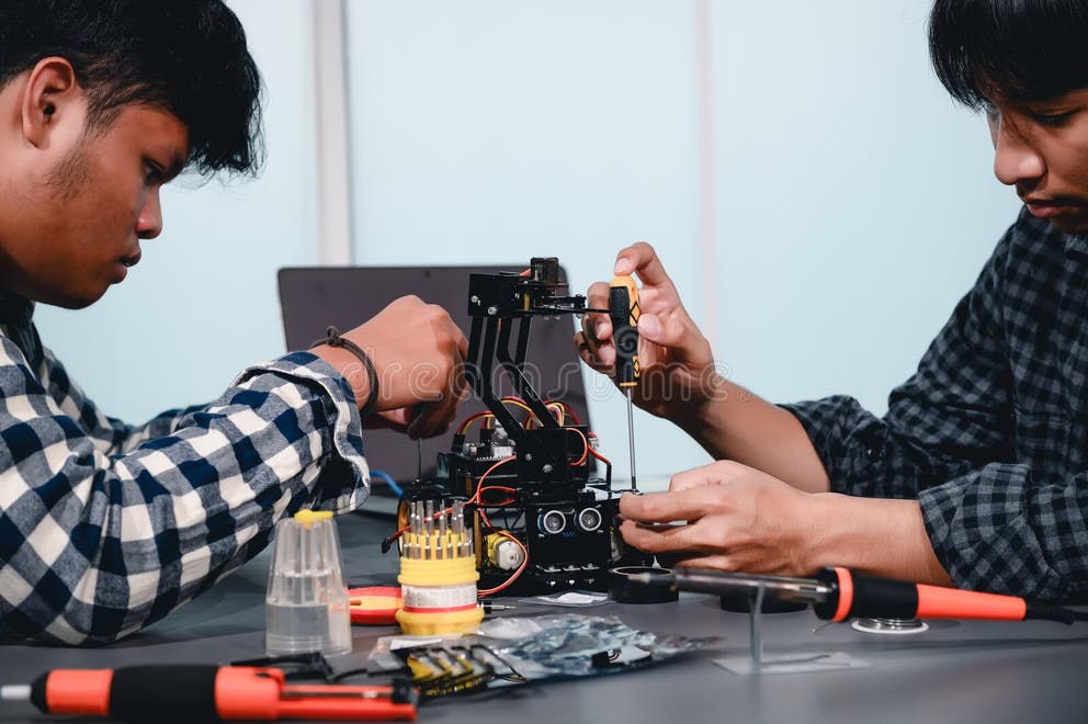 Engineer Asian Students Assembling Robotics Kits. Learning Mechanical ...