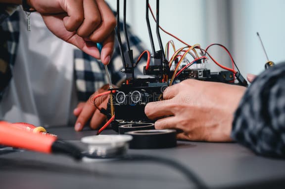 Engineer Asian Students Assembling Robotics Kits. Learning Mechanical Control, Robotics Combines ...