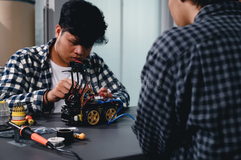 Engineer Asian Students Assembling Robotics Kits. Learning Mechanical ... Engineer Asian Students Assembling Robotics Kits. Learning Mechanical ...