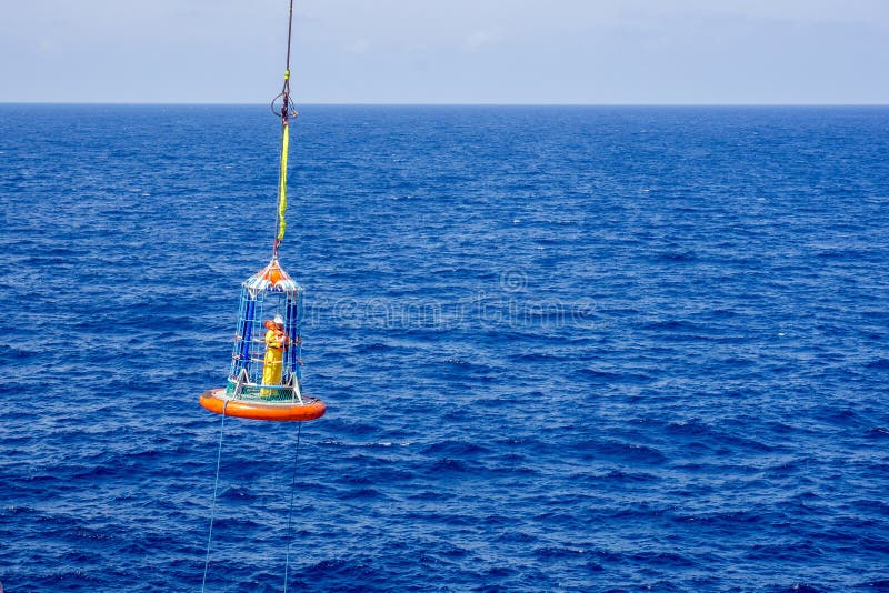 An Engineer Being Transferred from a Boat To a Construction Work Barge ...