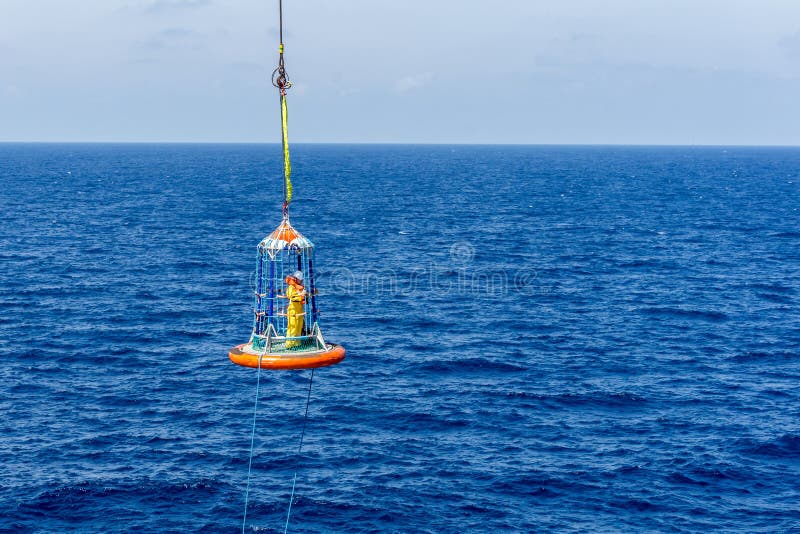 An Engineer Being Transferred from a Boat To a Construction Work Barge ...