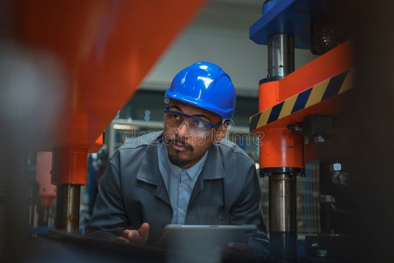 Engineer with a Blue Helmet and Safety Glasses, Checking Manufacturing ...