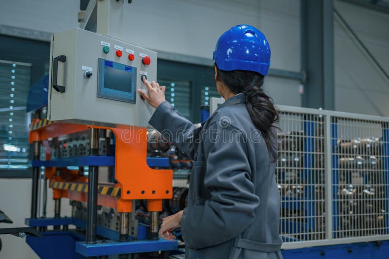 Engineer with Blue Helmet and Safety Goggles, Operating a Control Panel ...