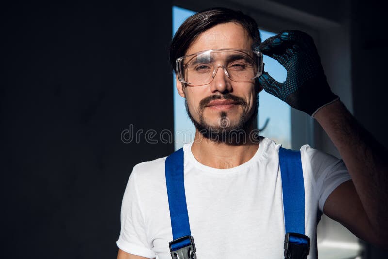 Engineer in Blue Overalls, White Shirt and Goggles Stock Image - Image ...