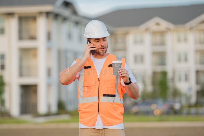 Engineer Builder Drinking Take Away Coffee Using Phone on Break ...