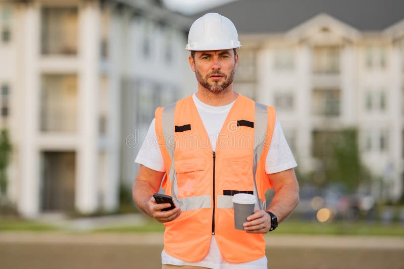 Engineer Builder Drinking Take Away Coffee Using Phone on Break ...