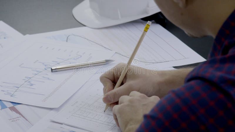 Engineer Builder at His Desk Performs a Pencil Drawing on Paper. Stock ...