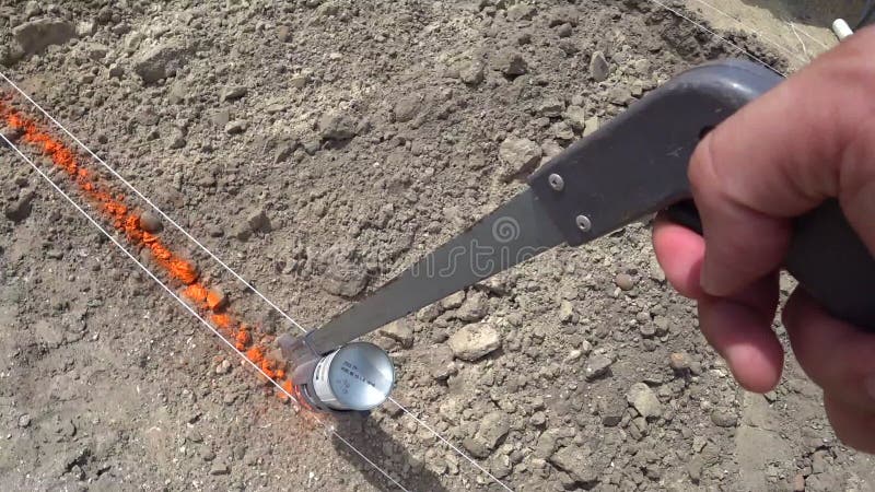 An Engineer Builder Makes a Marking with Orange Paint on a Construction ...