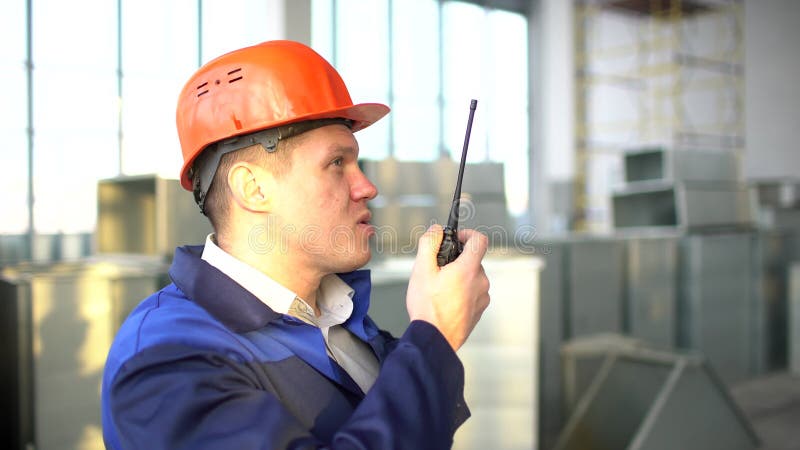 Engineer Builder Using a Walkie Talkie Giving Instructions at a ...