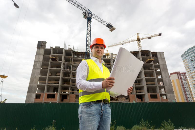 Engineer on Building Site with Blueprints Stock Image - Image of ...