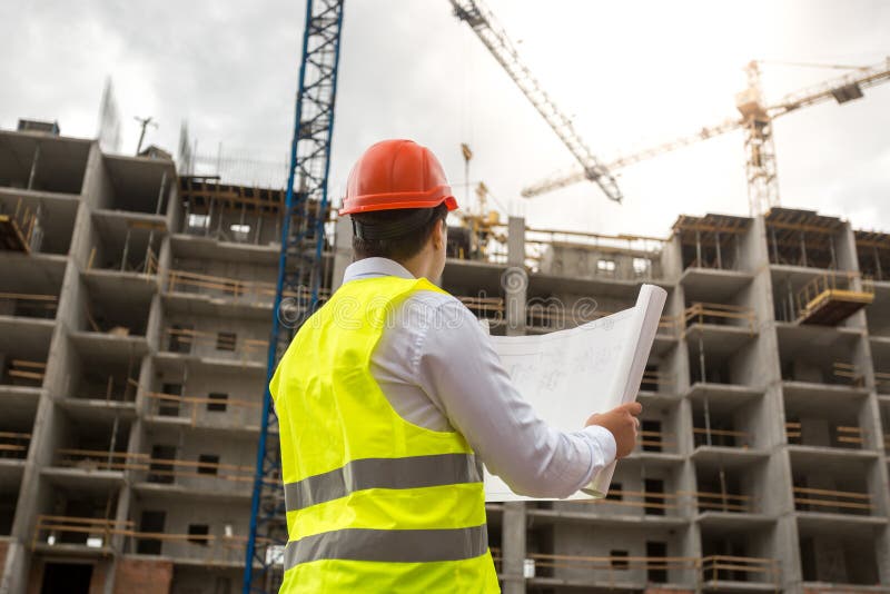 Construction Engineer Talking By Phone And Looking On Building S Stock ...