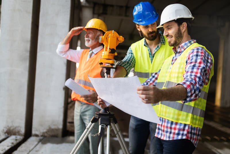 Engineer and Building Site Manager Dealing with Blueprints and Plans ...