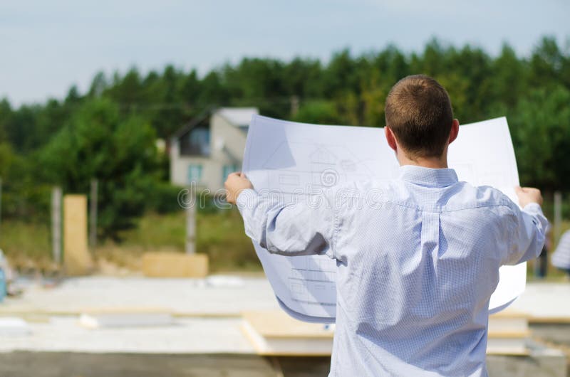 Engineer Checking a Building Plan on Site Stock Photo - Image of ...