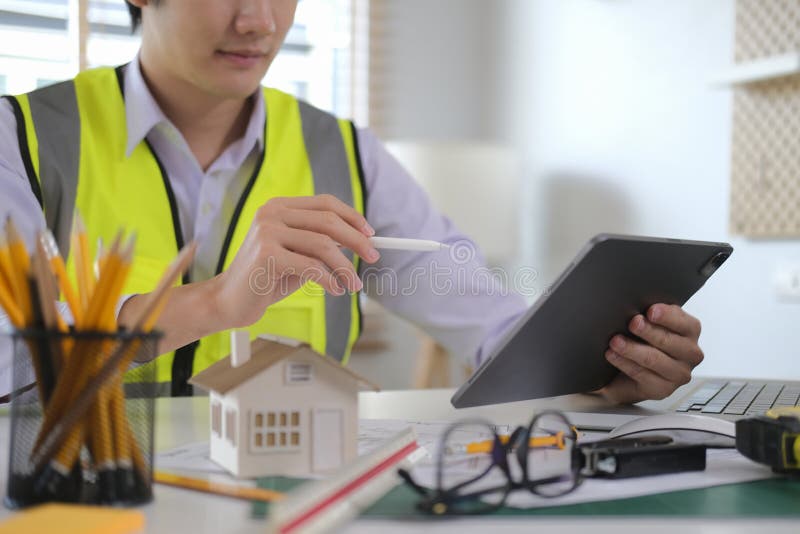 Engineer Checking Information on a Digital Tablet Working on ...
