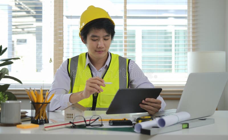 Engineer Checking Information on a Digital Tablet Working on ...