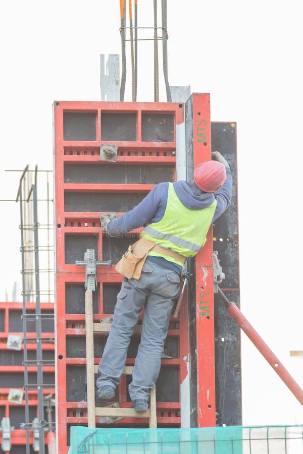 An Engineer is Climbing Up the Stairs at the Constraction Site ...