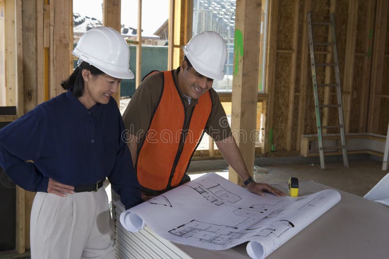 Engineer and Co-Worker Working Over Blueprint Stock Photo - Image of ...
