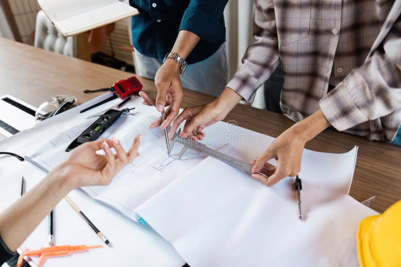 Collaborative Engineers Working on Architectural Blueprint and ...