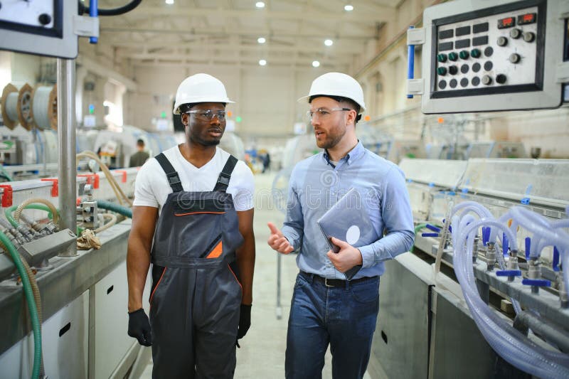 An Engineer Communicates with a Worker on a Production Line Stock Photo ...