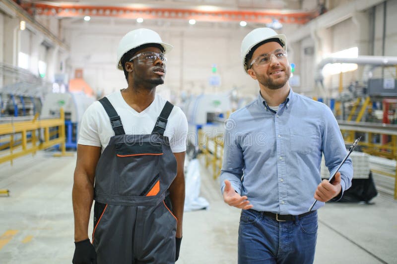 An Engineer Communicates with a Worker on a Production Line Stock Image ...