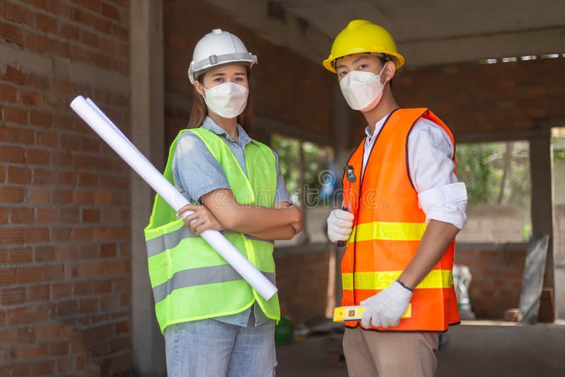 Engineer Concept the Two Engineers Holding Paper Plan, Hammer and Other ...