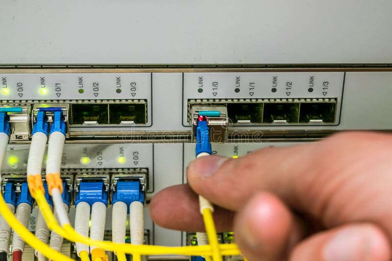 The Engineer Connects the Optical Internet Cable with the Central ...