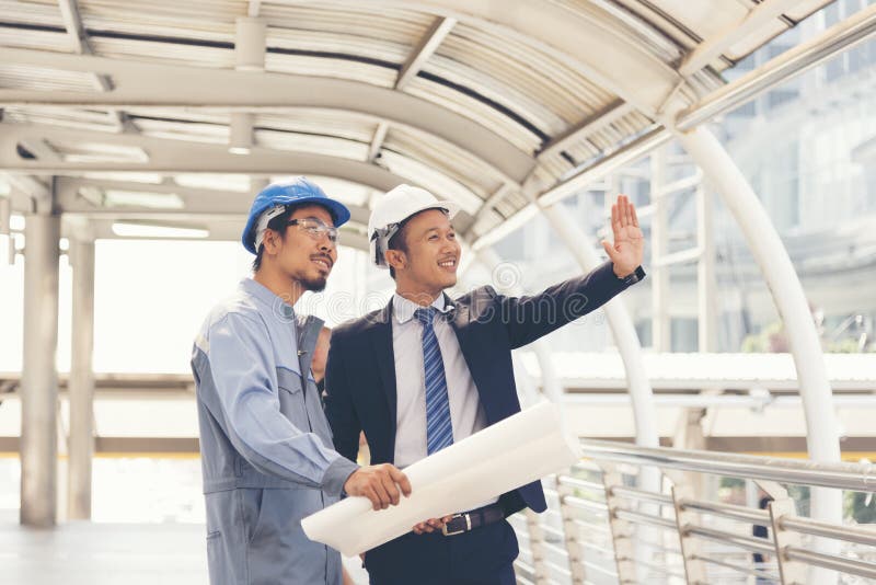 Engineer and Construction Manager Foreman Working on Building Site ...