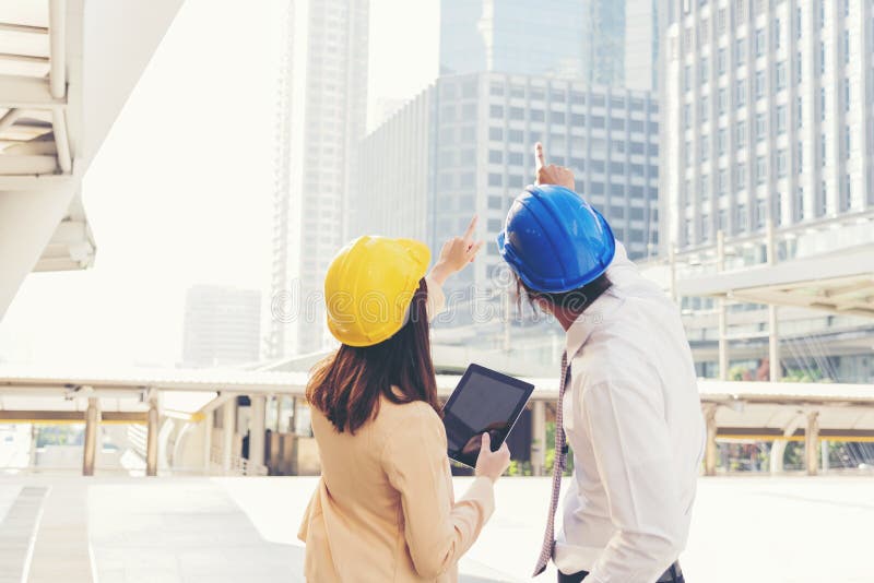 Engineer and Construction Manager Foreman Working on Building Site ...
