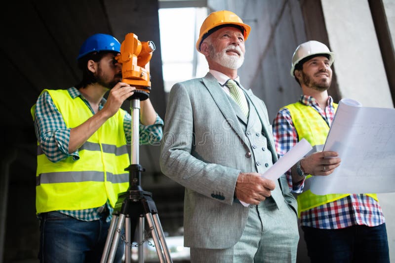 Engineer and Construction Site Manager Dealing with Blueprints and ...