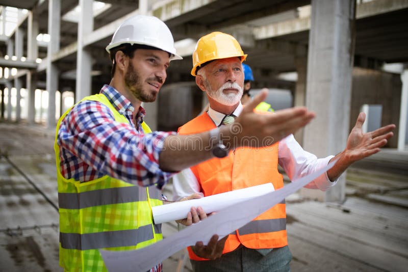 Engineer and Construction Site Manager Dealing with Blueprints and ...
