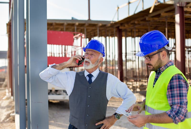 Engineer and Construction Worker at Building Site Stock Image - Image ...