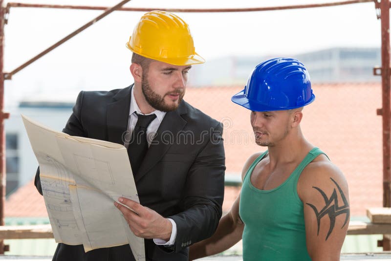 Engineer and Construction Worker Discussing a Project Stock Image ...