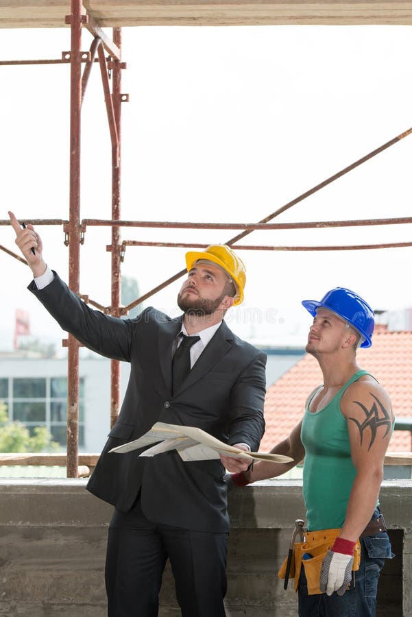Engineer and Construction Worker Discussing a Project Stock Photo ...