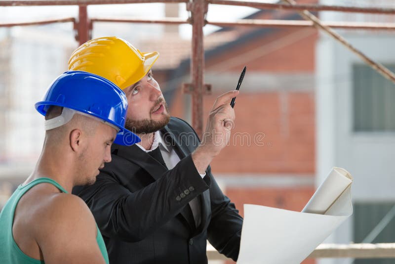 Engineer and Construction Worker Discussing a Project Stock Image ...