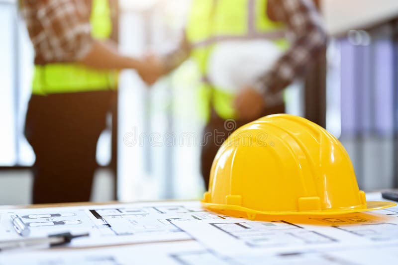 Engineer or Construction Worker Workspace with a Yellow Hardhat and ...