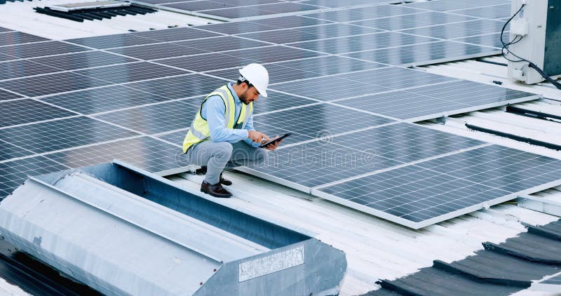 Engineer or Contractor Measuring Solar Panels on a Roof of a Building ...
