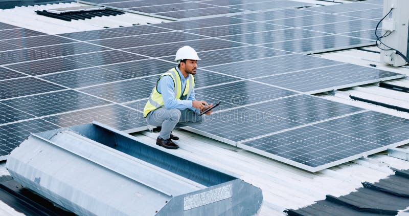 Engineer or Contractor Measuring Solar Panels on a Roof of a Building ...