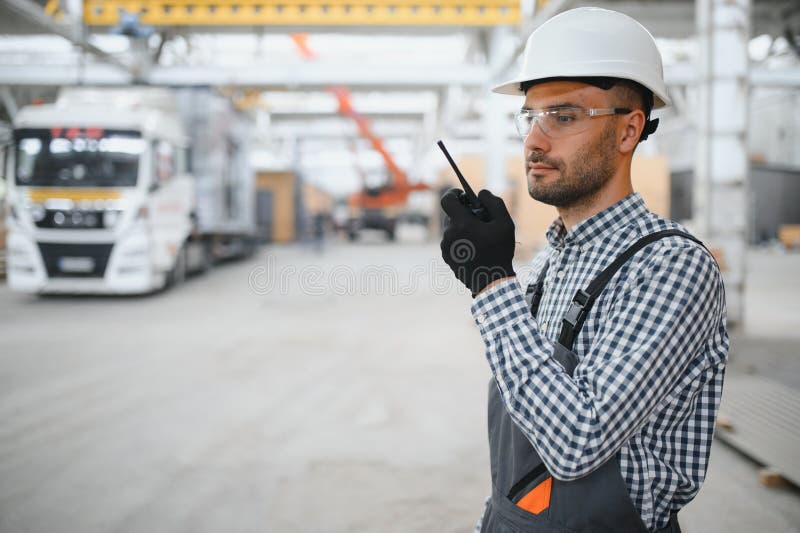 An Engineer Controls the Production of Modular Houses and Uses a Walkie ...