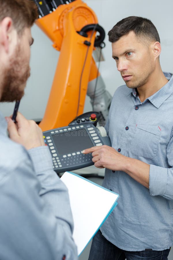 Engineer Demonstrates Robotic Arm Control To Female Visitors Stock ...