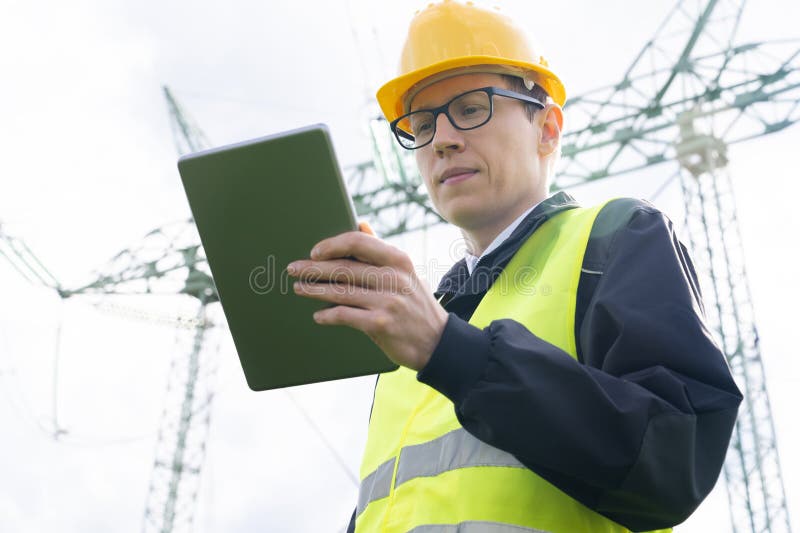 Engineer with Digital Tablet on a Background of Power Line Tower Stock ...